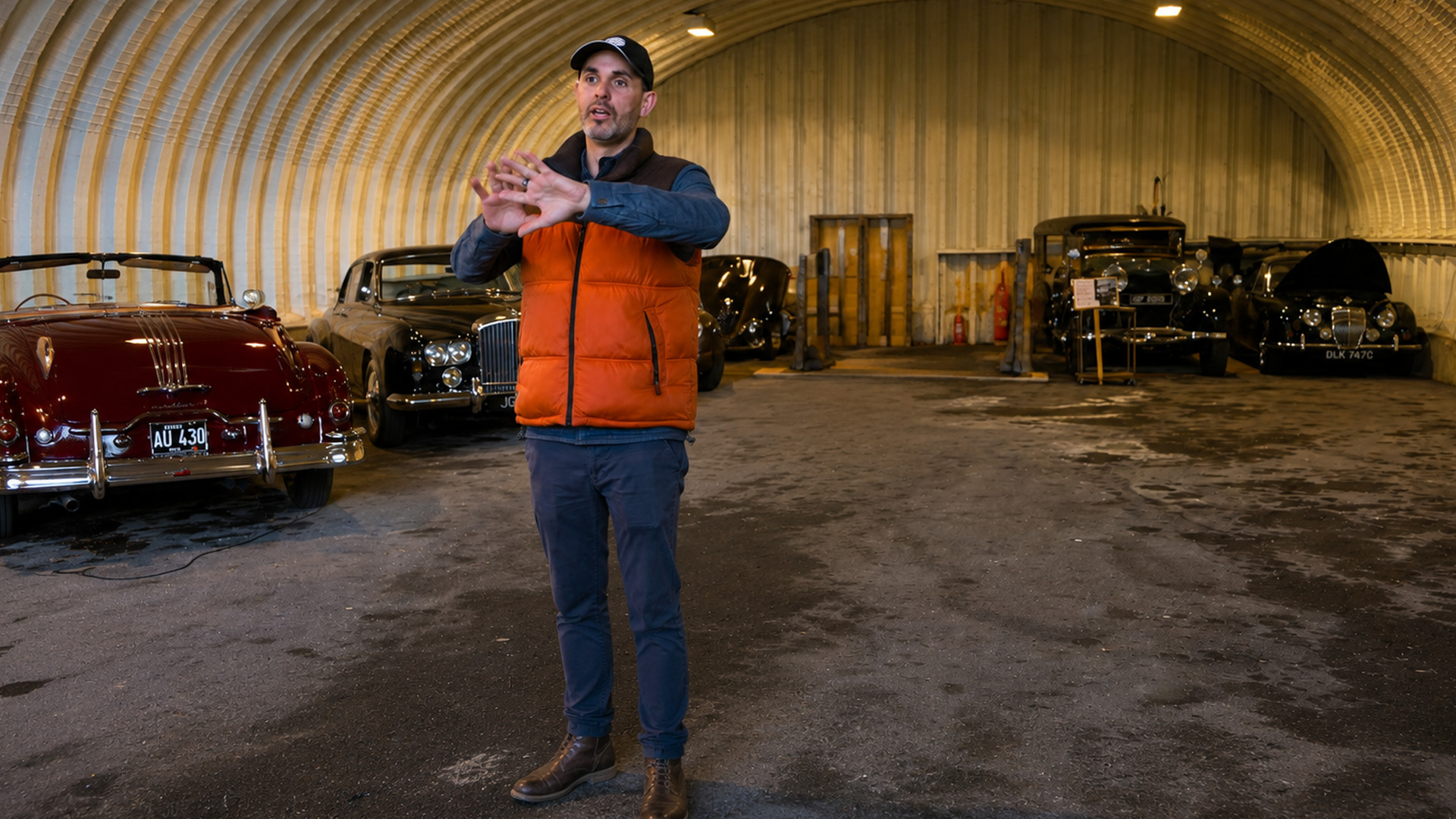 A look at a lineup of classic cars in a hidden garage