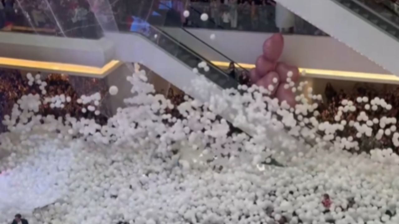 Shoppers look up as thousands of balloons finally drop