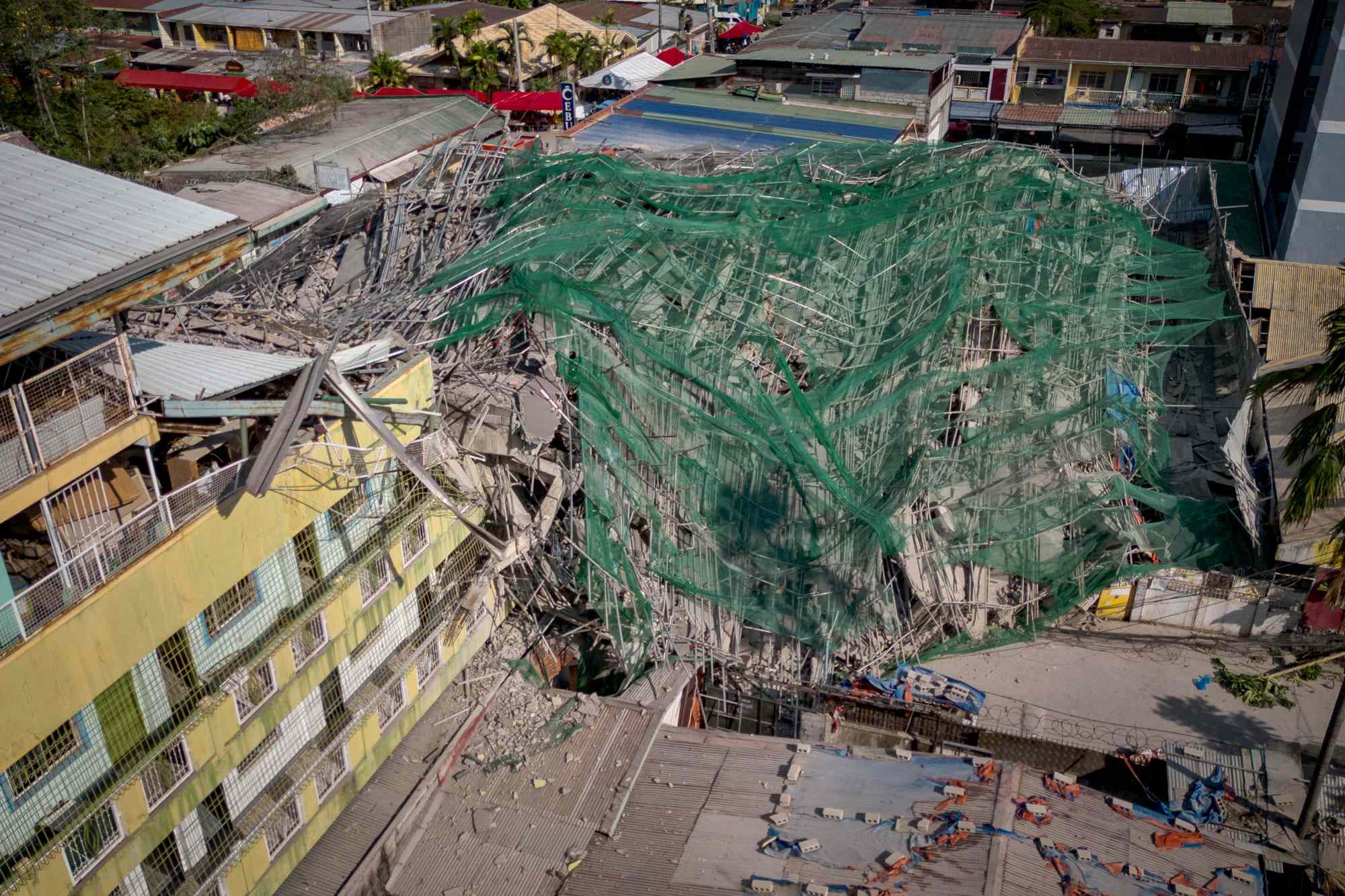 At least 21 people trapped after 9-story building under construction ...