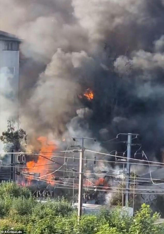 Rail chaos in London as enormous fire breaks out beside tracks ...