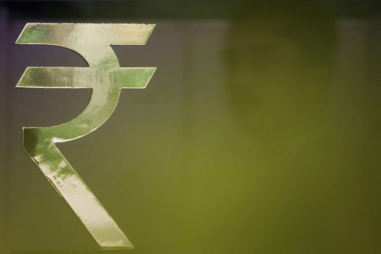 Rupee gains to two-week high, forward premiums dip as oil prices slump