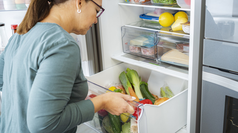 Use old dish towels to create budget-friendly fridge liners