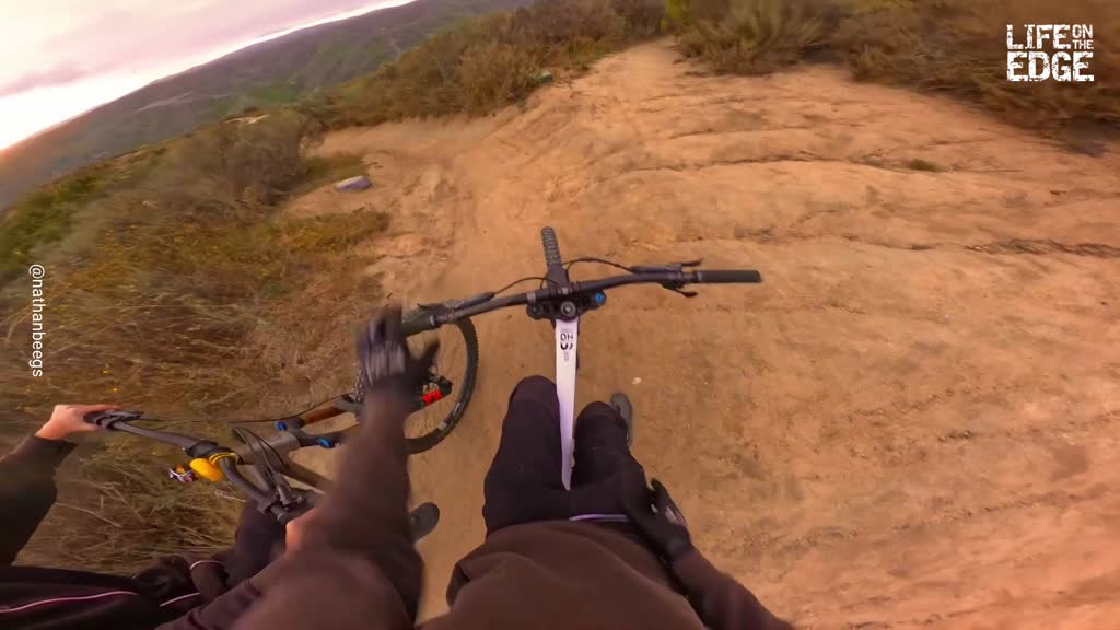 Scary moment biker almost falls off cliff