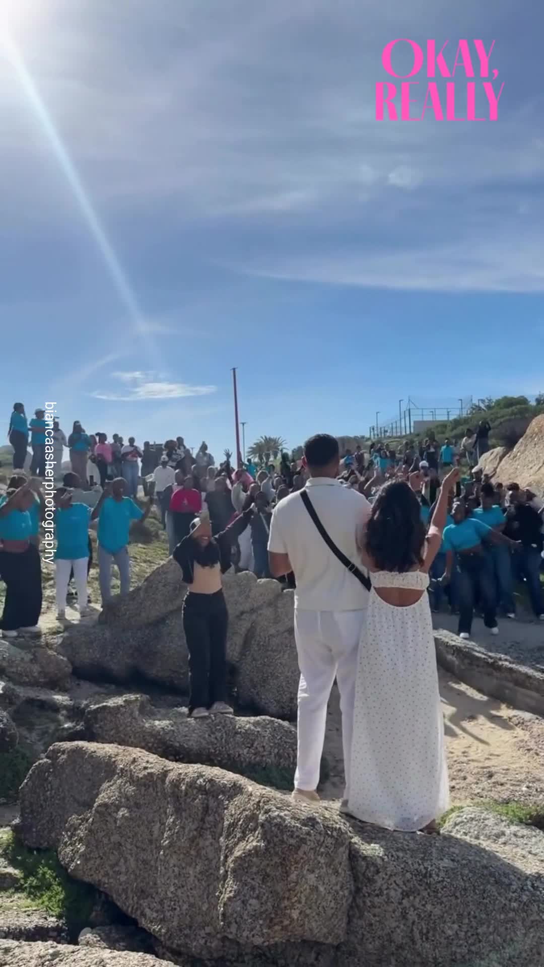 Massive crowd erupts into cheers and dancing after beach proposal