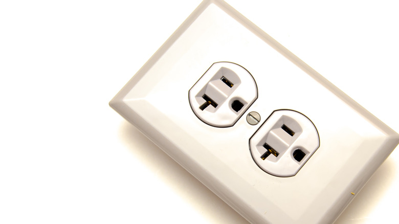 Why do some electrical outlets have a T-shaped hole?