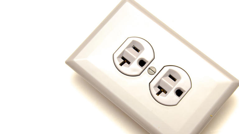 Why do some electrical outlets have a T-shaped hole?