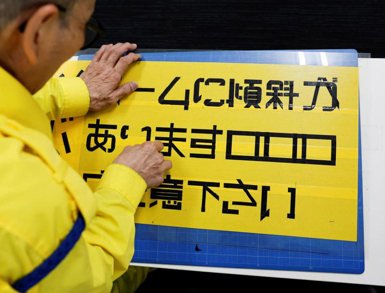 Japanese security guard finds fame as designer of duct tape signs