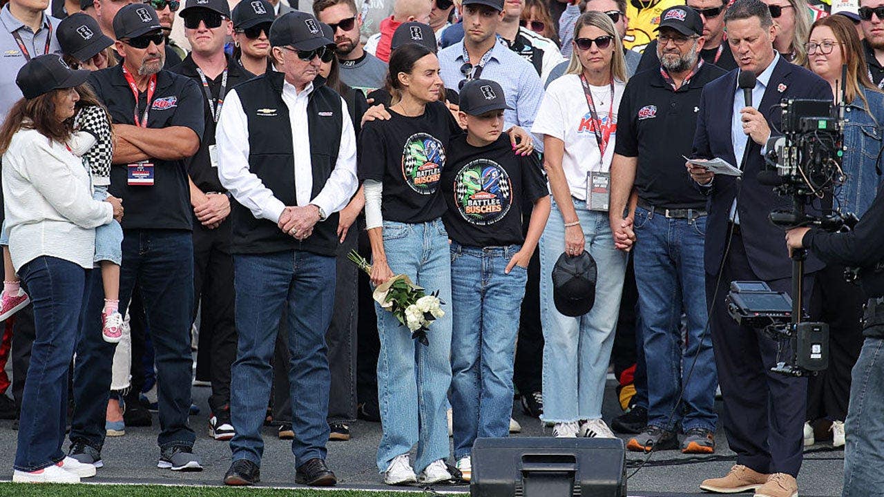 Kyle Busch's family surrounded by drivers and team owners during ...