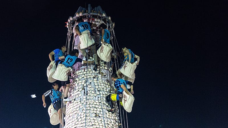 Climbers race up giant bun tower at Hong Kong’s colourful Bun Festival
