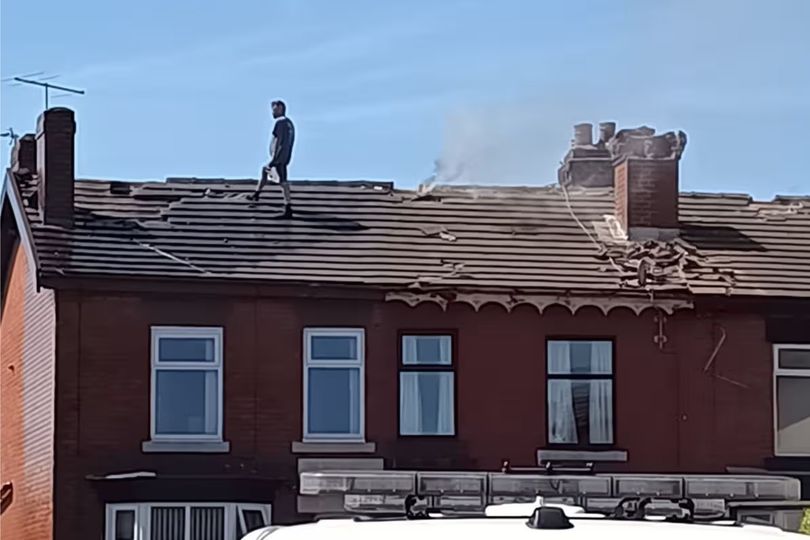 Man on roof throws bricks and sets fire in six-hour-long stand off with ...