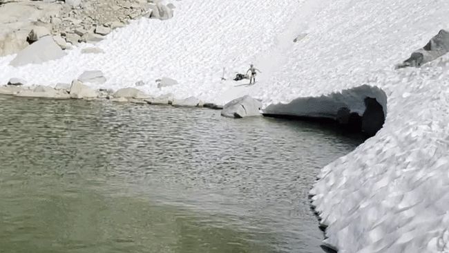 Unreal moment skier skims across surface of pond