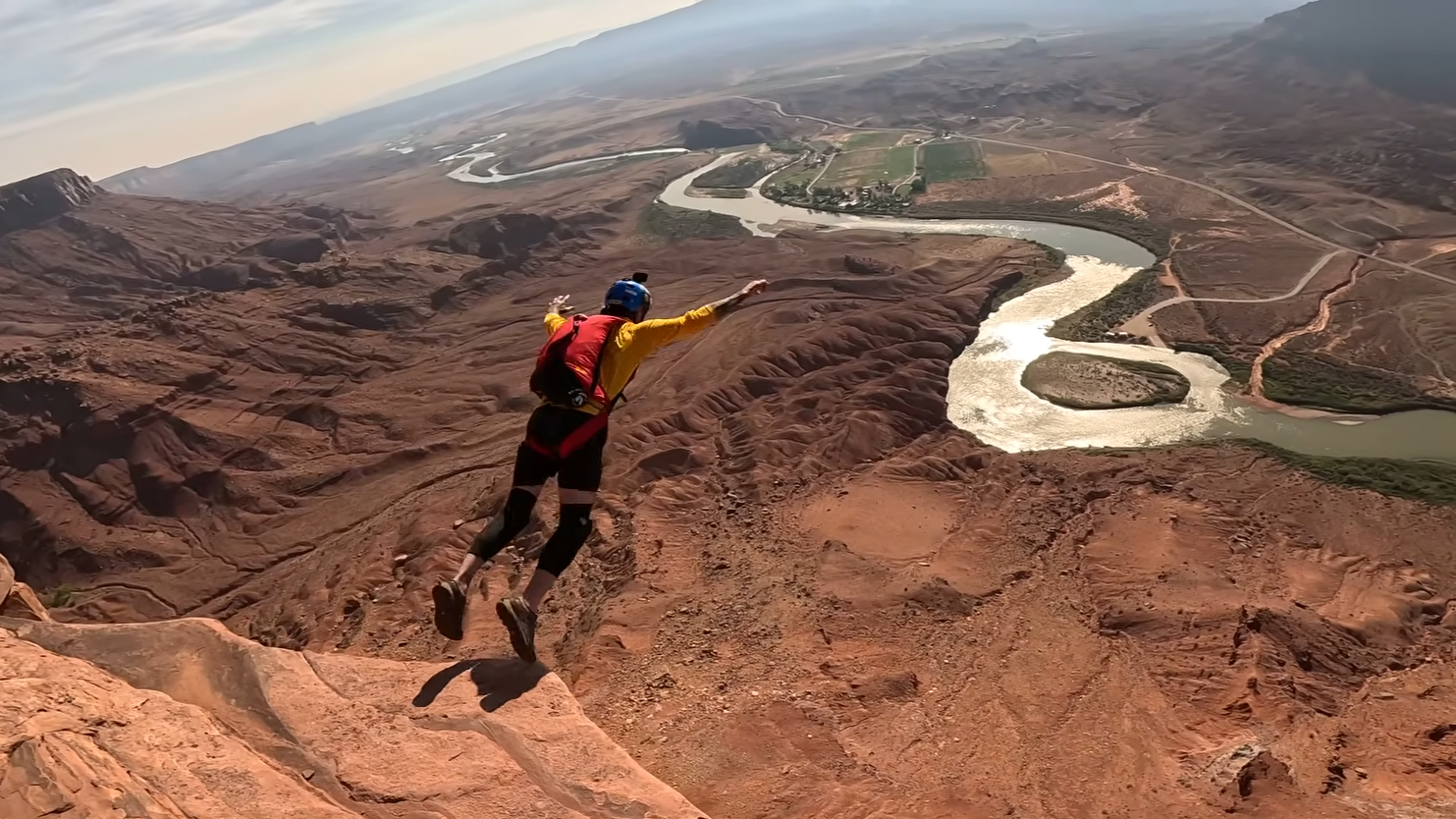 Man jumps from a cliff into a gorgeous valley