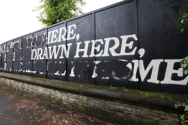 Anger as mural opposite Manchester hotel at centre of furious protests ...