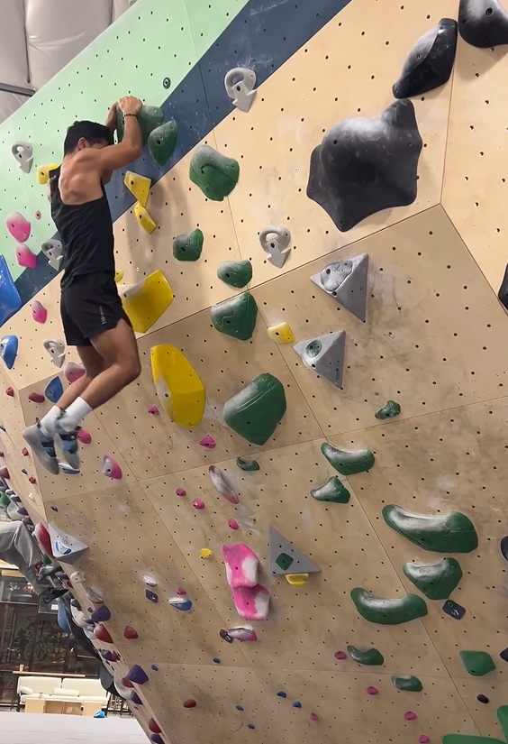 A gym athlete trying indoor rock climbing for the first time