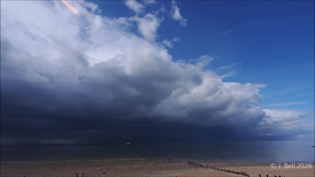 Dramatic storm cloud interupts blue skies over Thames Estuary, UK