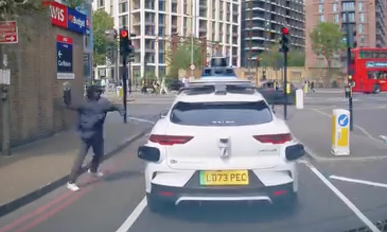 Moment man hurls 'rock' at Waymo multiple times - before 'driverless ...