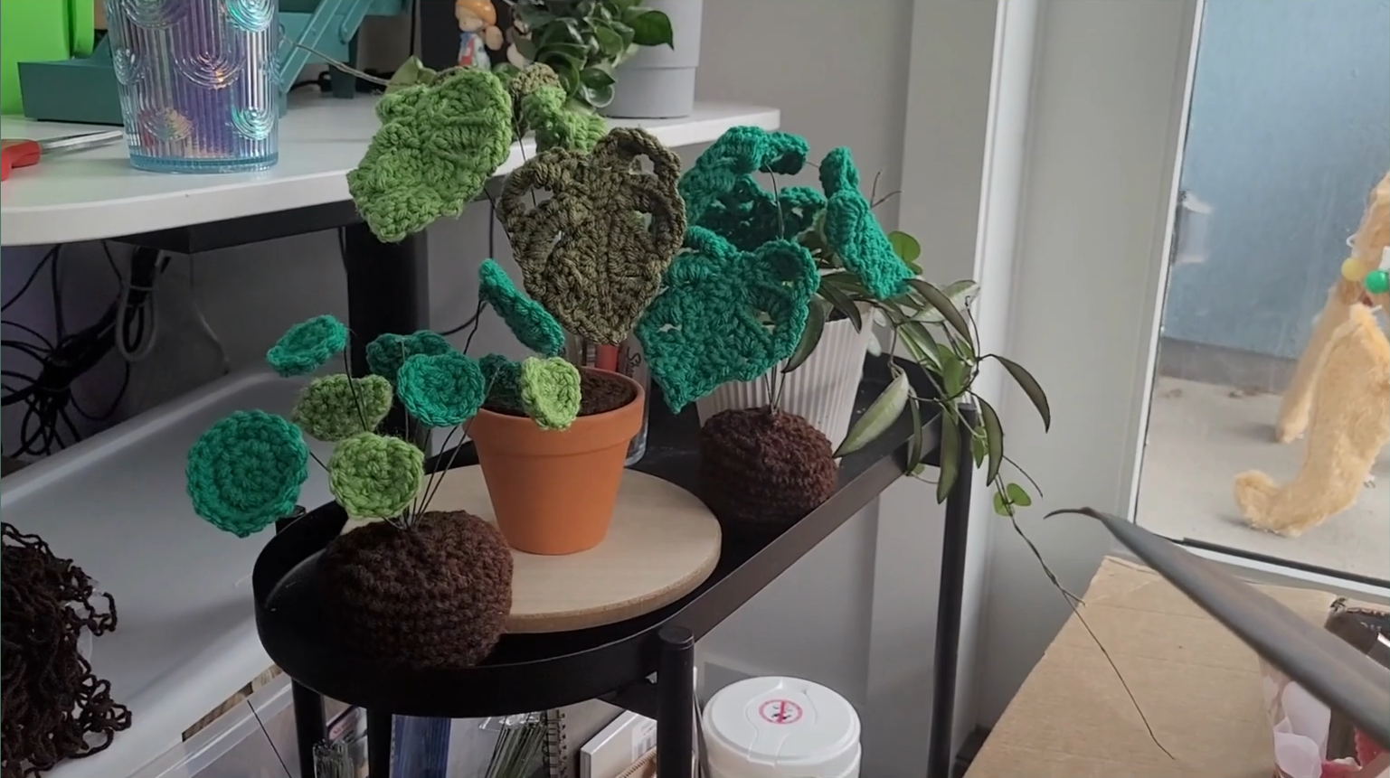 Crochet plants and flower lights turn a craft table into a handmade garden