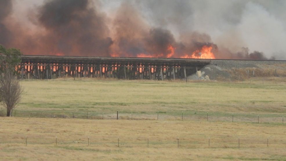 Railroad trestle in canyon engulfed in flames from wildfires, collapses