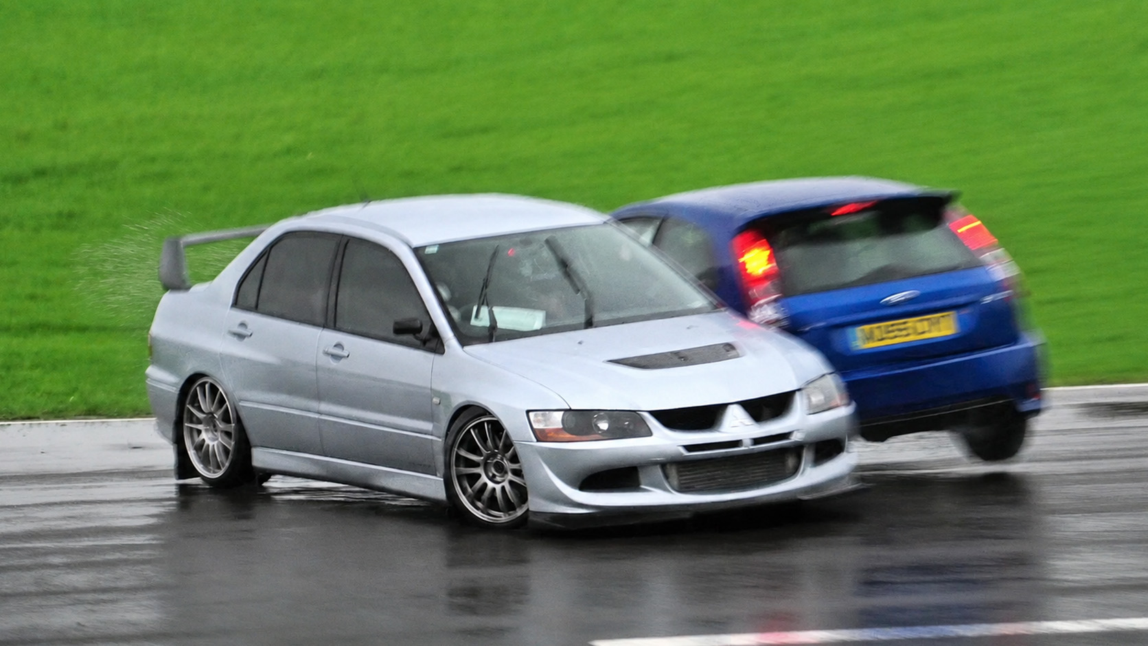 Fiesta crashes into Mitsubishi Evo during heavy rain