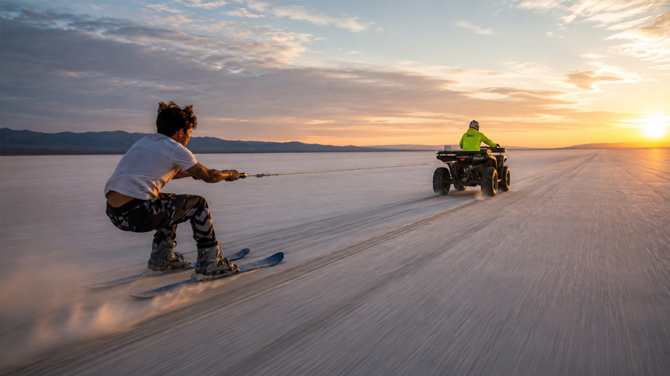 Snowboards glide across massive salt flats at speed