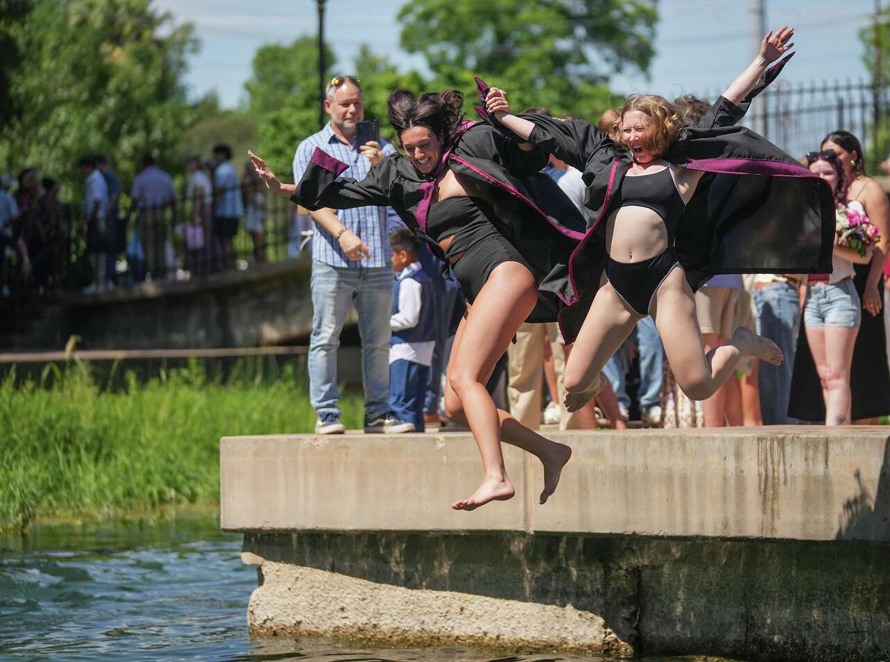 Texas State graduates celebrate with San Marcos River jump tradition