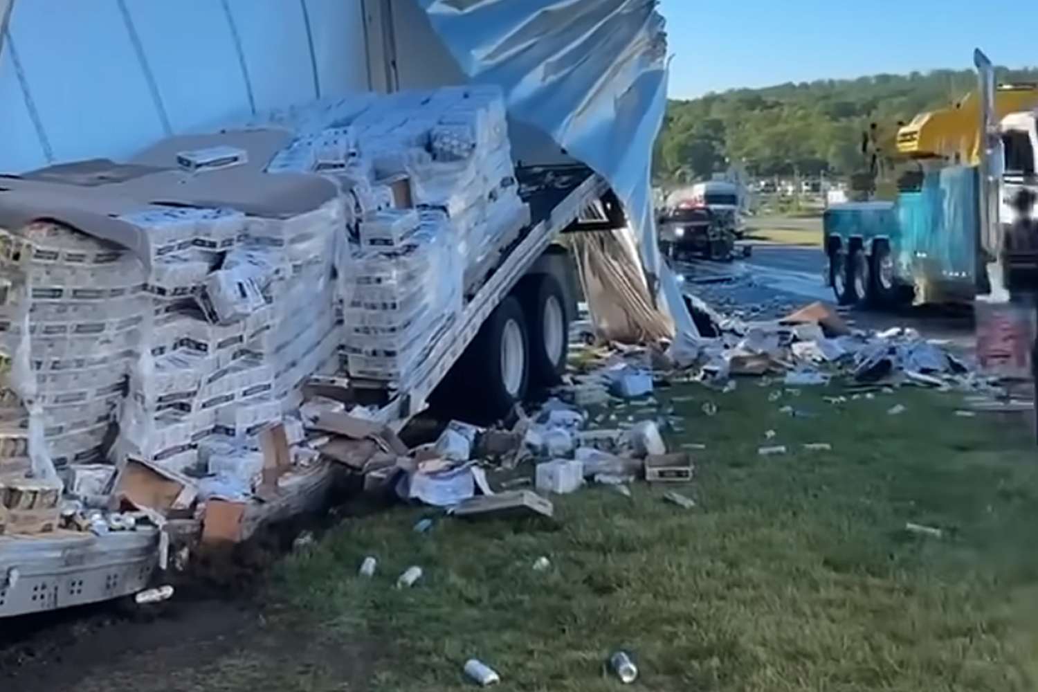Tractor trailer crashes, spilling cases of White Claw on highway