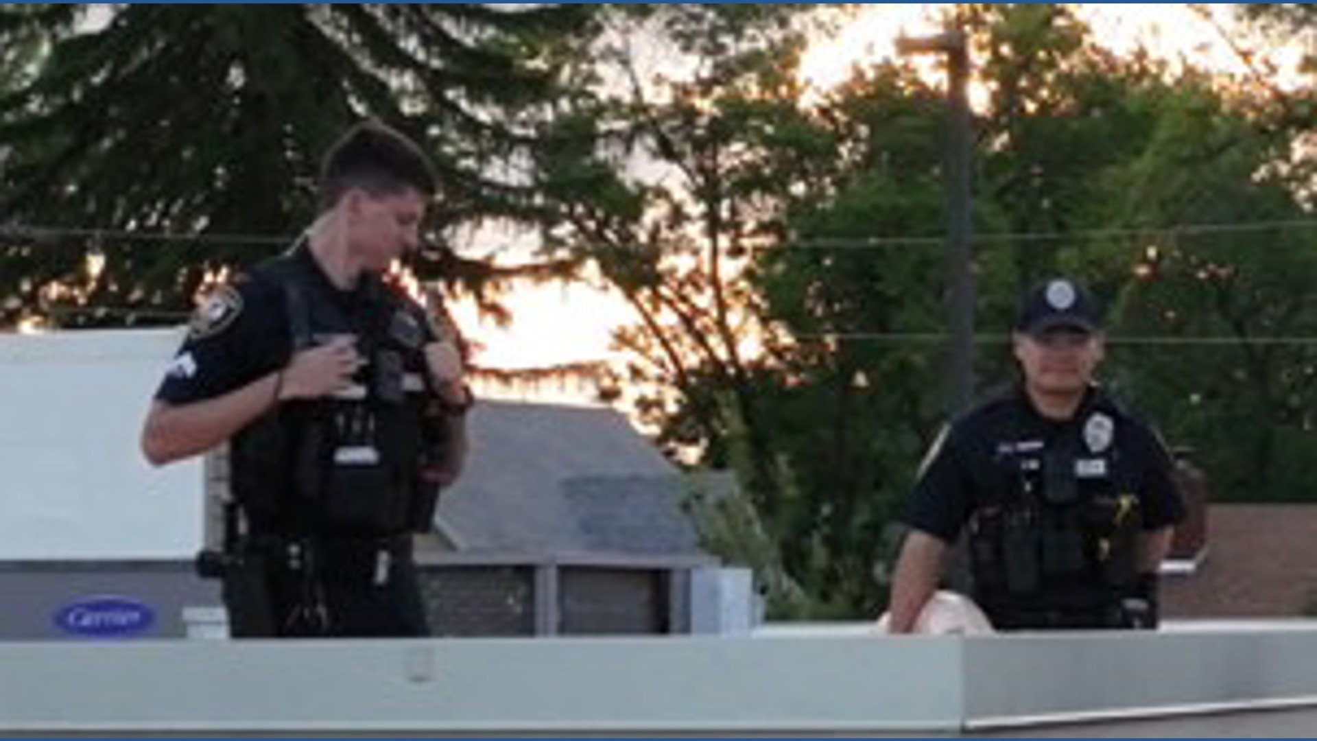 Cop on a rooftop from the News 8 drone