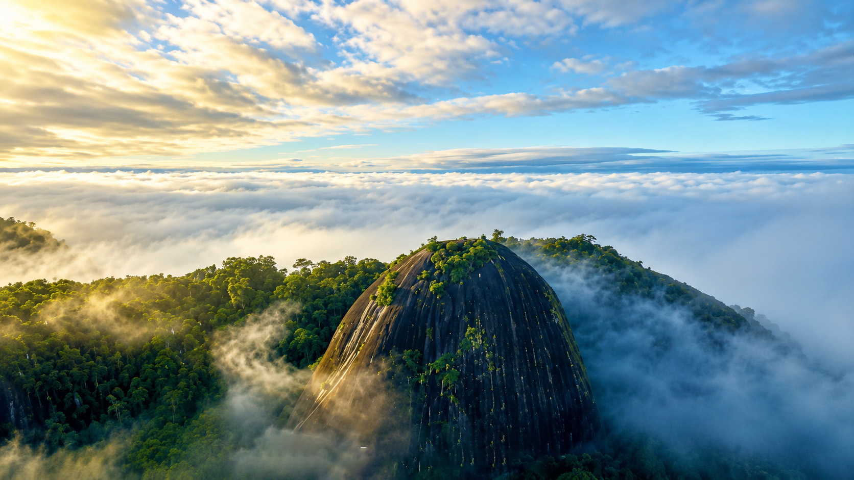 A massive dome emerging from a sea of clouds