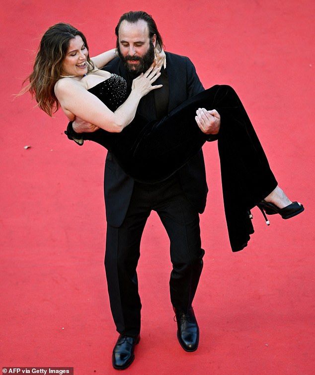 Vincent Macaigne carries model Laetitia Casta along the red carpet amid ...