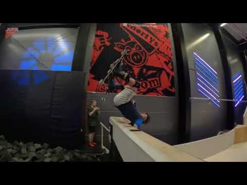 Guy hits elbow on ski ramp and falls into foam pit