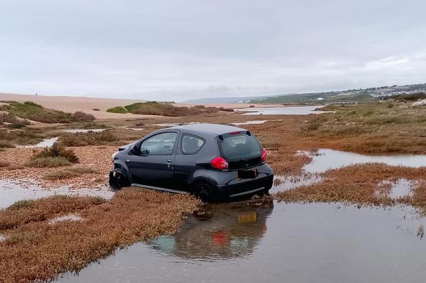 Car ends up near beach after leaving road in dramatic crash