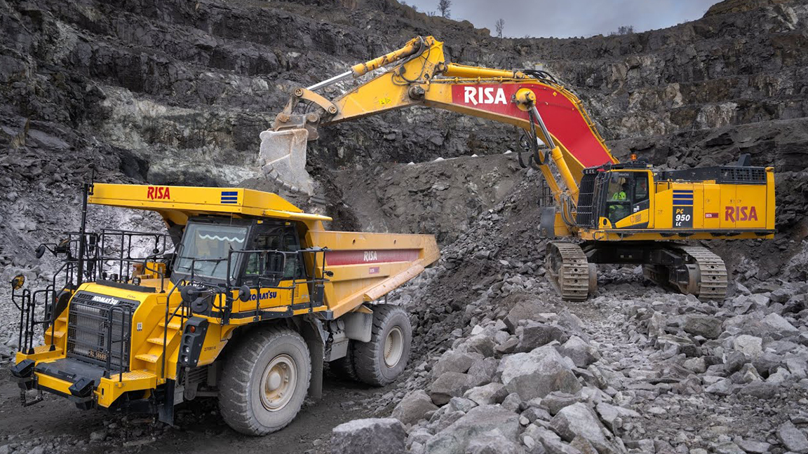 Large hydraulic excavator performing rock loading operations