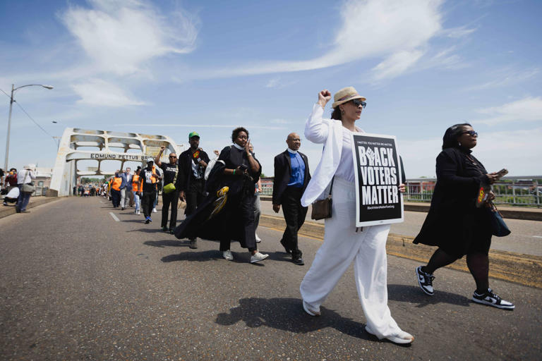 Voting rights activists take symbolic walk across famous bridge as ...