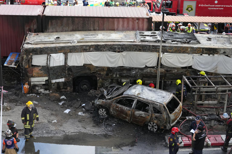 A cargo train hits a public bus at a Bangkok rail crossing, killing at ...
