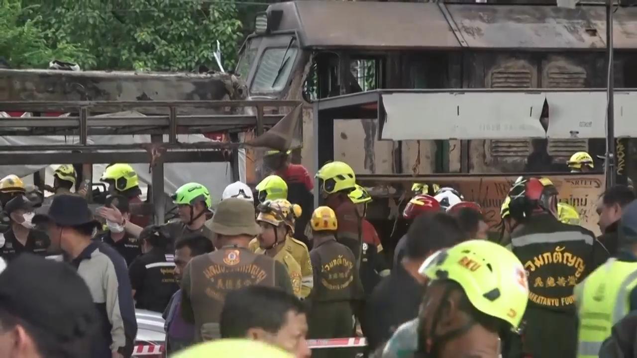 Cargo train hits a public bus in deadly crash at Bangkok rail crossing