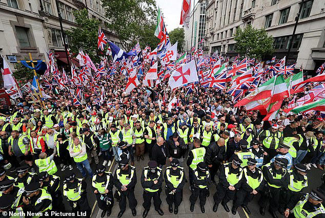 Protesters light flares on Churchill statue as Met arrests 31 in rival ...