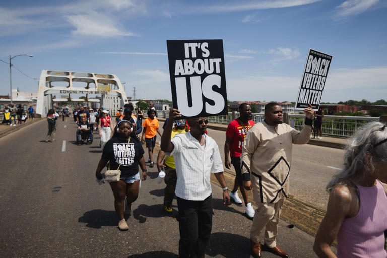 Voting rights activists take symbolic walk across famous bridge as ...