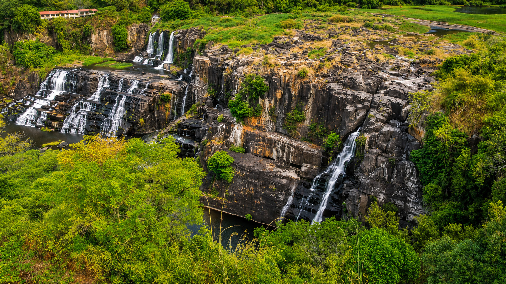 A giant tiered waterfall spreading across stone terraces
