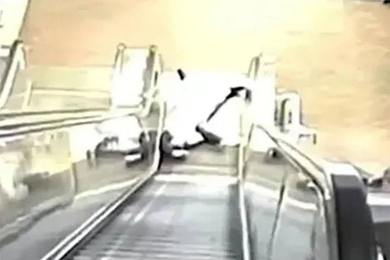 Dad dies after getting trapped in escalator as commuters walk past in ...