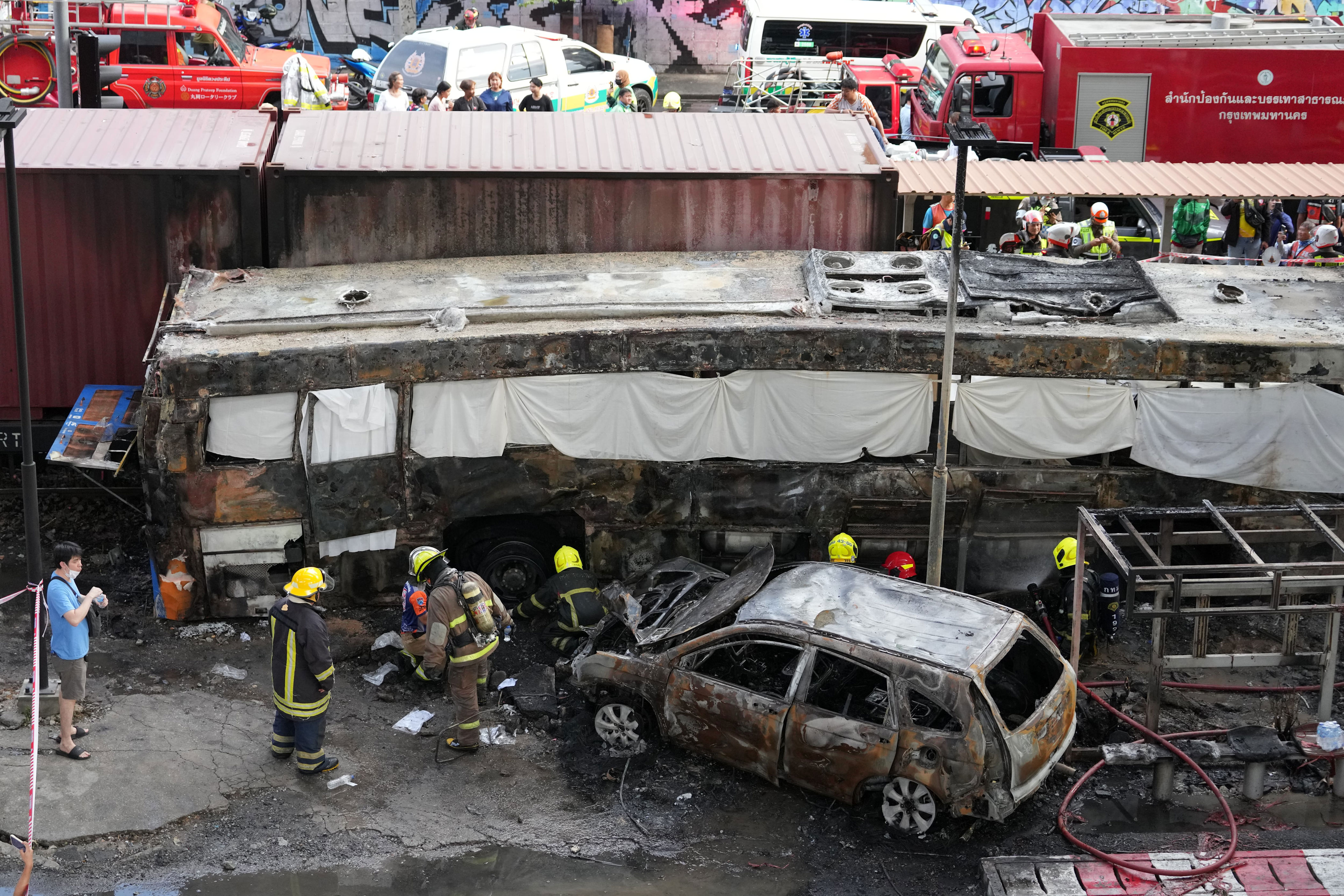 A cargo train hits a public bus at a Bangkok rail crossing, killing at ...