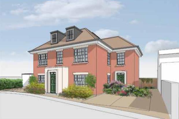 Plan to build four homes after demolishing site behind shopping parade