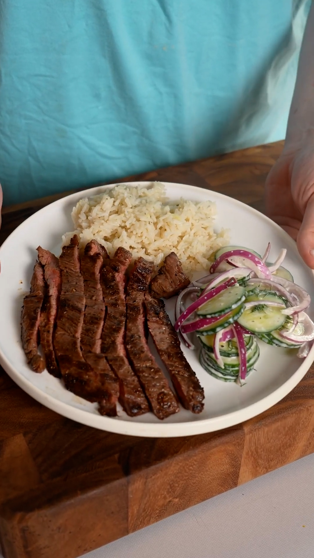 Marinated skirt steak sliced thin with cool cucumber salad