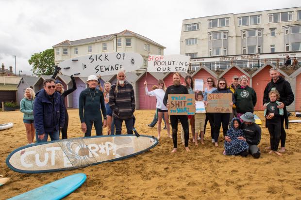 Dozens join island paddle-out to protest over sewage releases