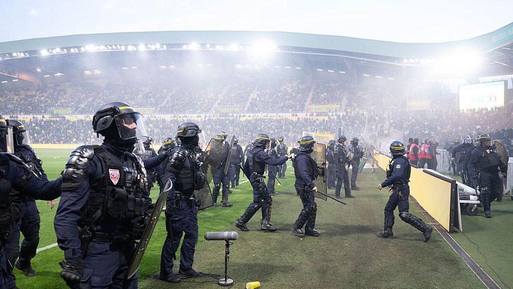 Ligue 1 game abandoned after fans invade pitch at relegated Nantes
