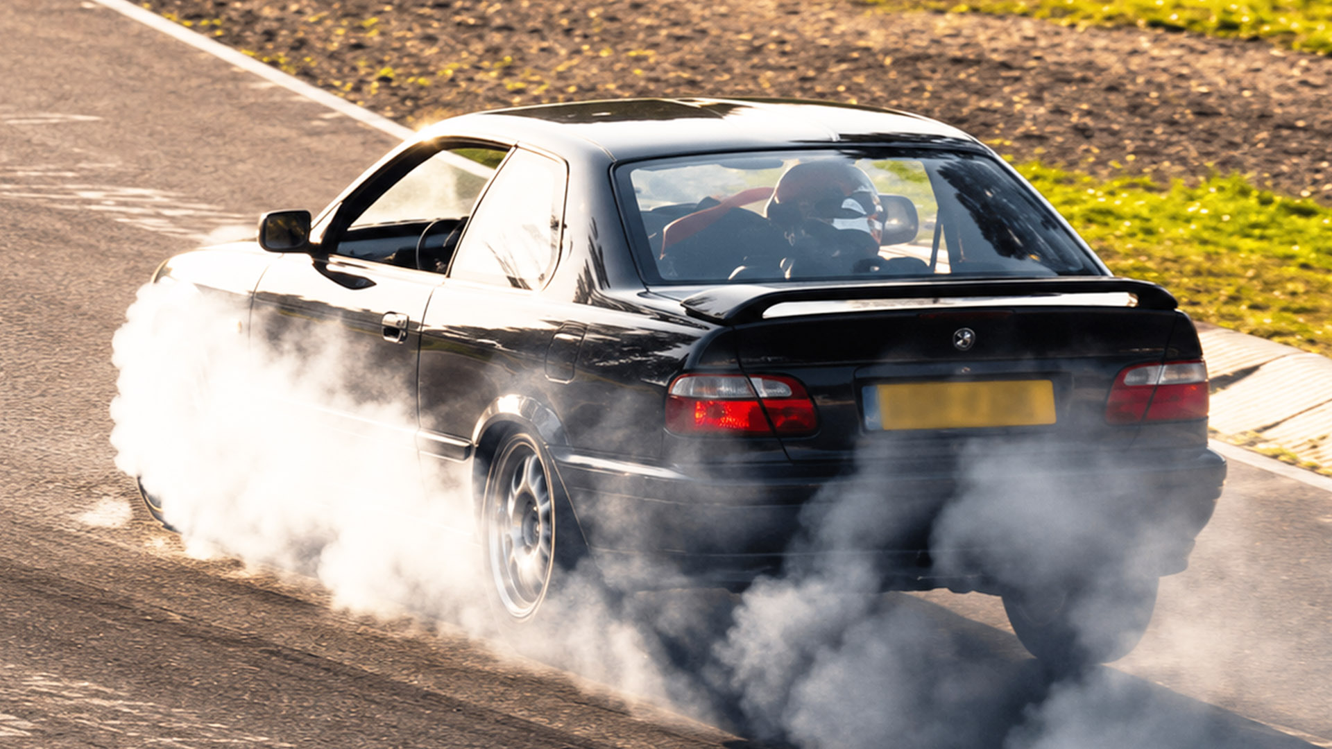 Tire smoke covers the road during Nürburgring public track activities