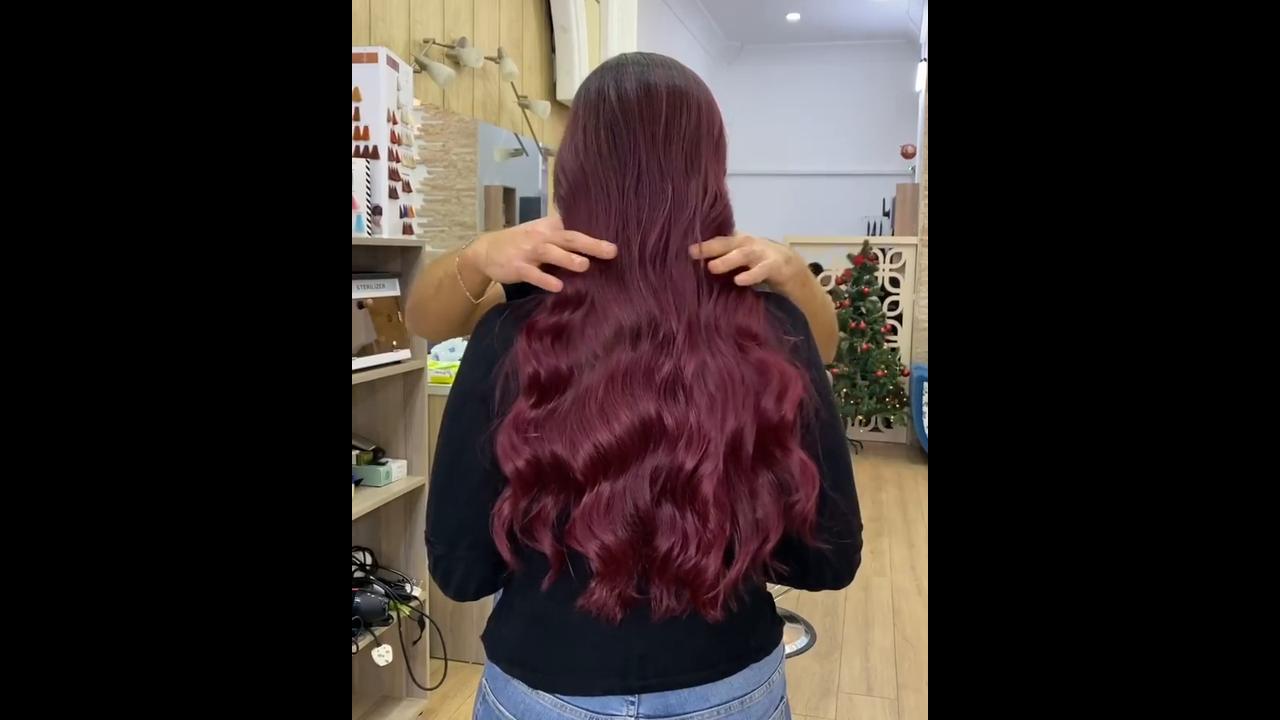 Styling extra long wine red hair with loose curling motion producing ...