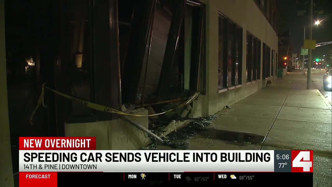 Car crashes into downtown building after colliding with speeding car