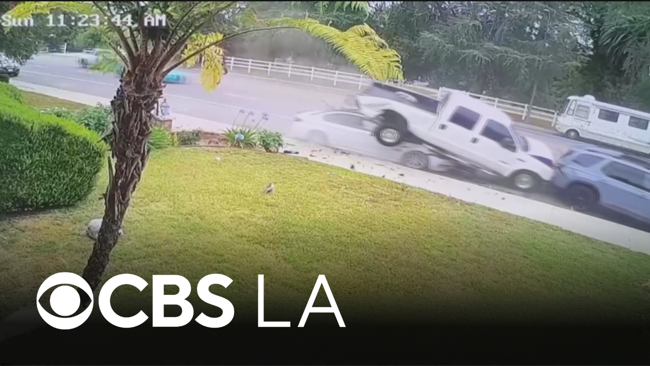 Surveillance camera captures moments car crashes underneath pickup ...