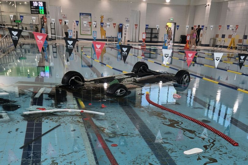 Watch OAP crash car through glass wall into indoor pool as woman swims ...