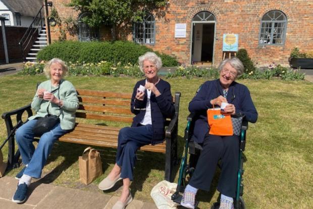 Care home residents enjoy ice cream and art on shopping village visit